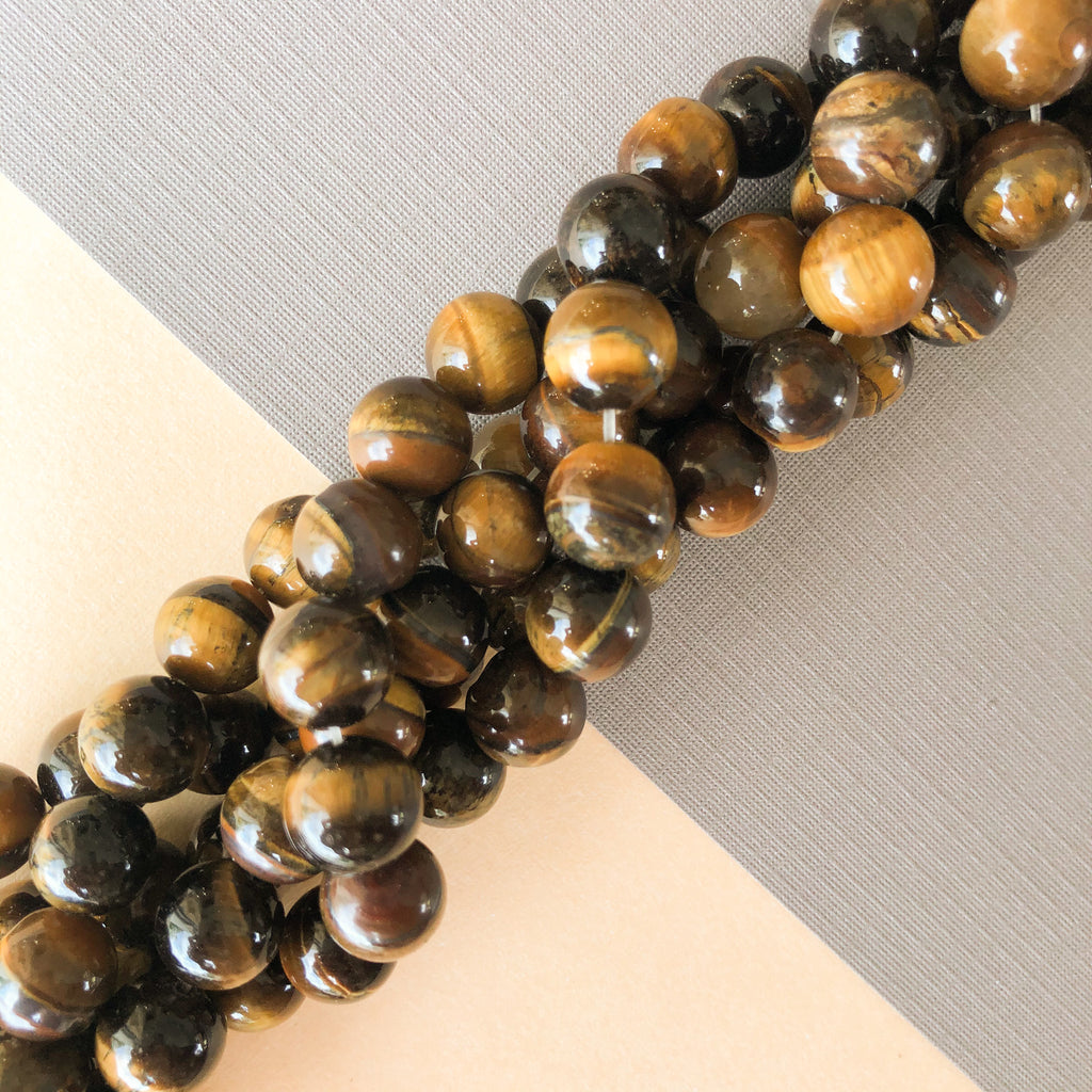 10mm Smooth Tigers Eye Round Strand – Beads, Inc.