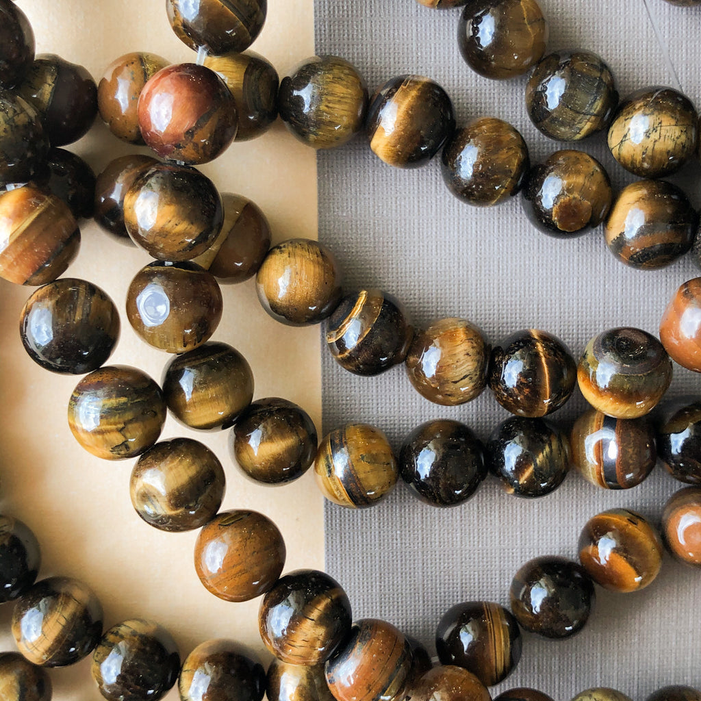 10mm Smooth Tigers Eye Round Strand – Beads, Inc.